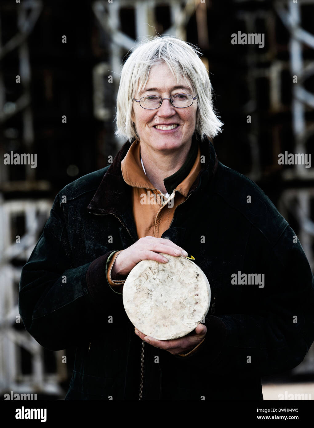 Owner Mary Quicke holding a cheese round at QuickesTraditional cheese ...