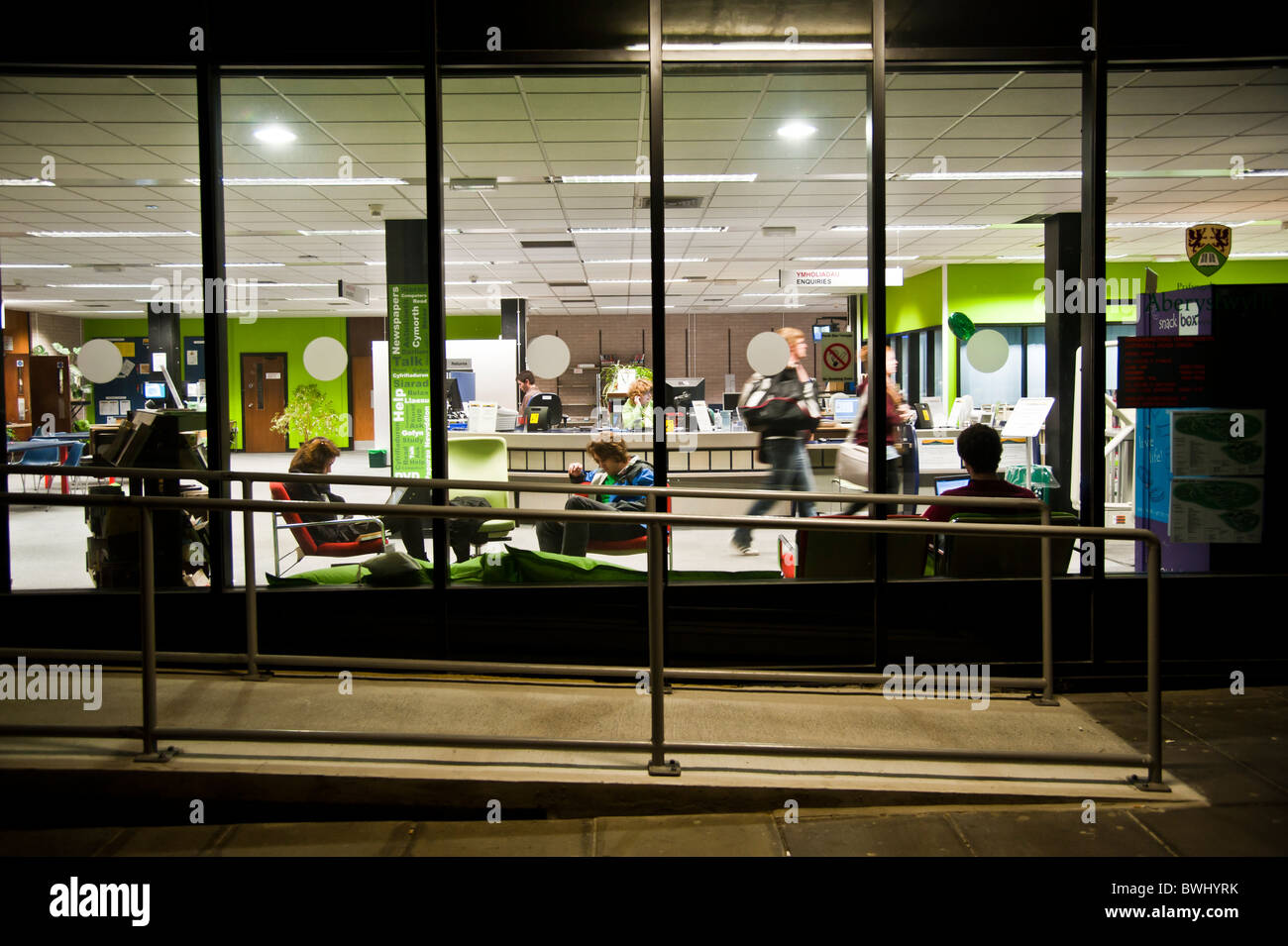 Students in the library of Aberystwyth University campus at night, UK ...