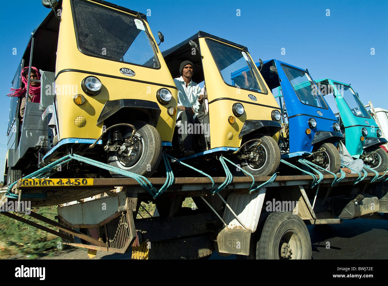 Motor rickshaws being delivered on the back of a lorry in Gujarat ...