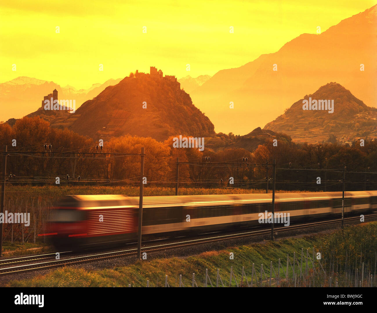 train SBB road railway railroad Sion hill mood dusk twilight yellow ...