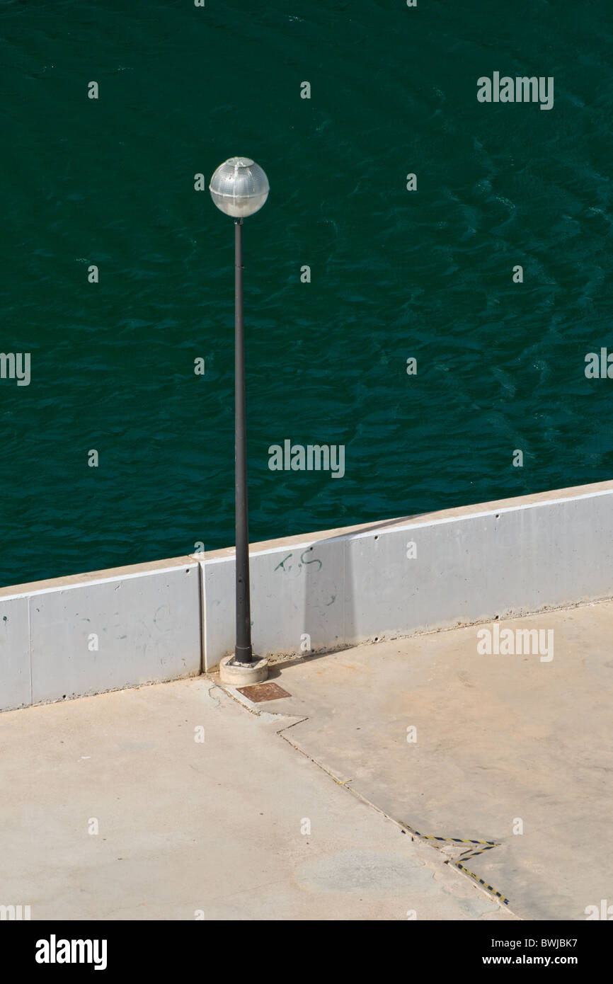 a single lamp post on the walk way Stock Photo - Alamy