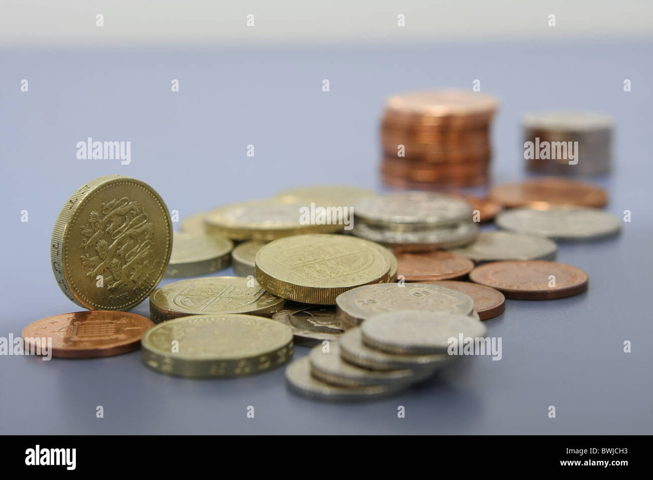 various denomination sterling coins in stacks and scattered Stock Photo ...