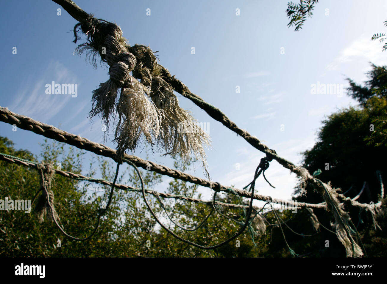 old rope bridge in field in countryside Stock Photo - Alamy