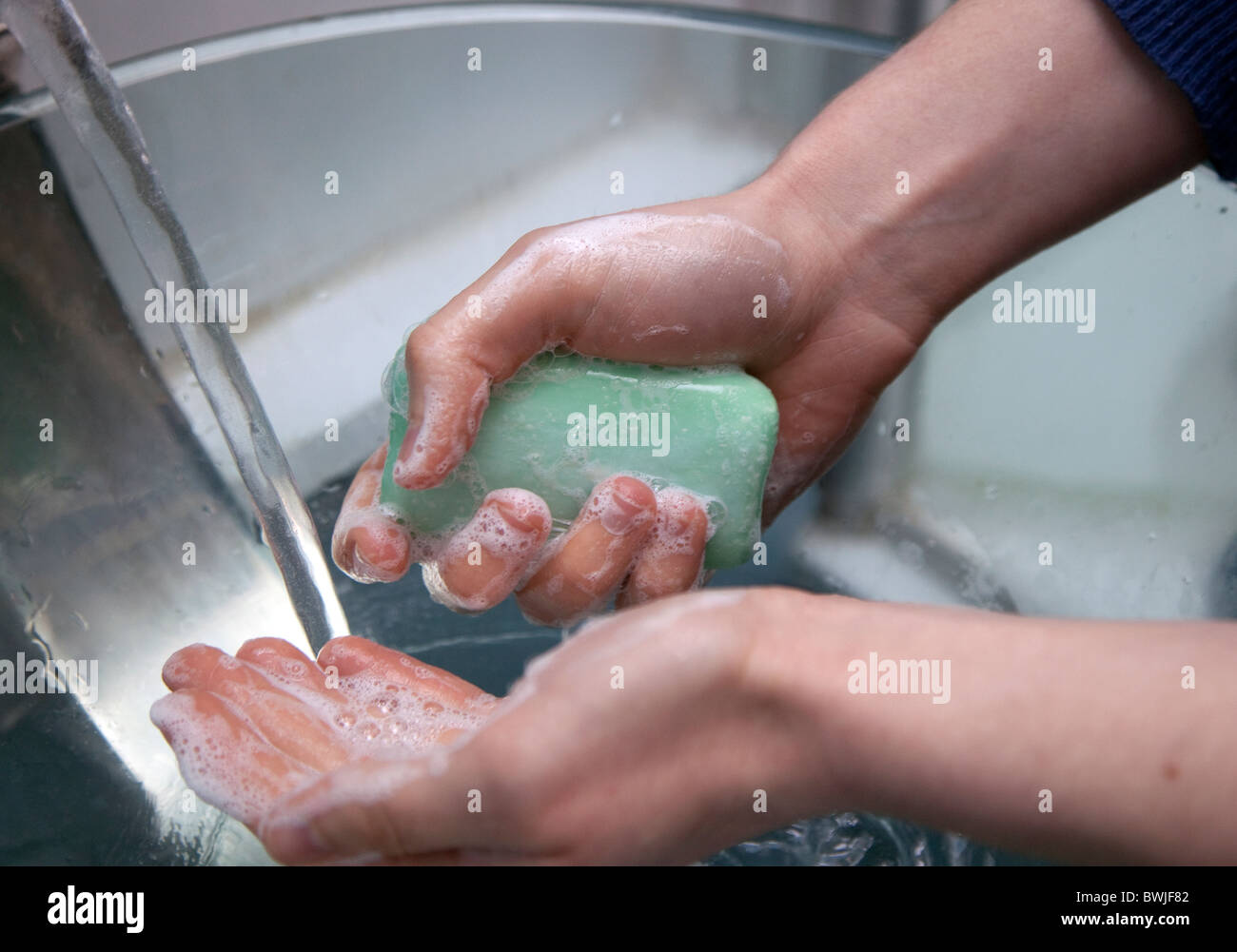 Washing hands using bar of soap, London Stock Photo - Alamy