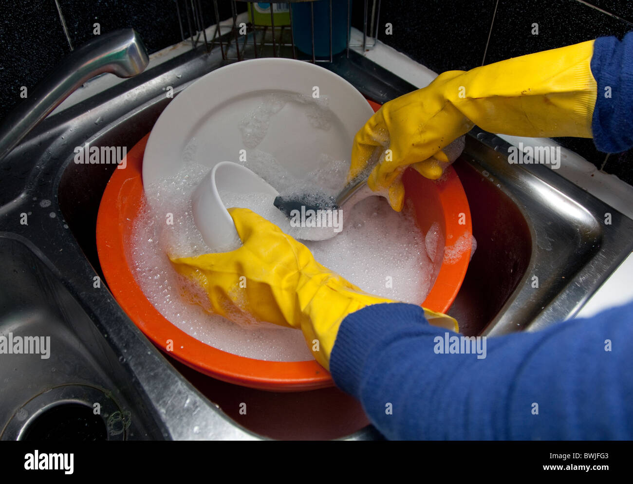 Washing up dishes in the home, London Stock Photo - Alamy