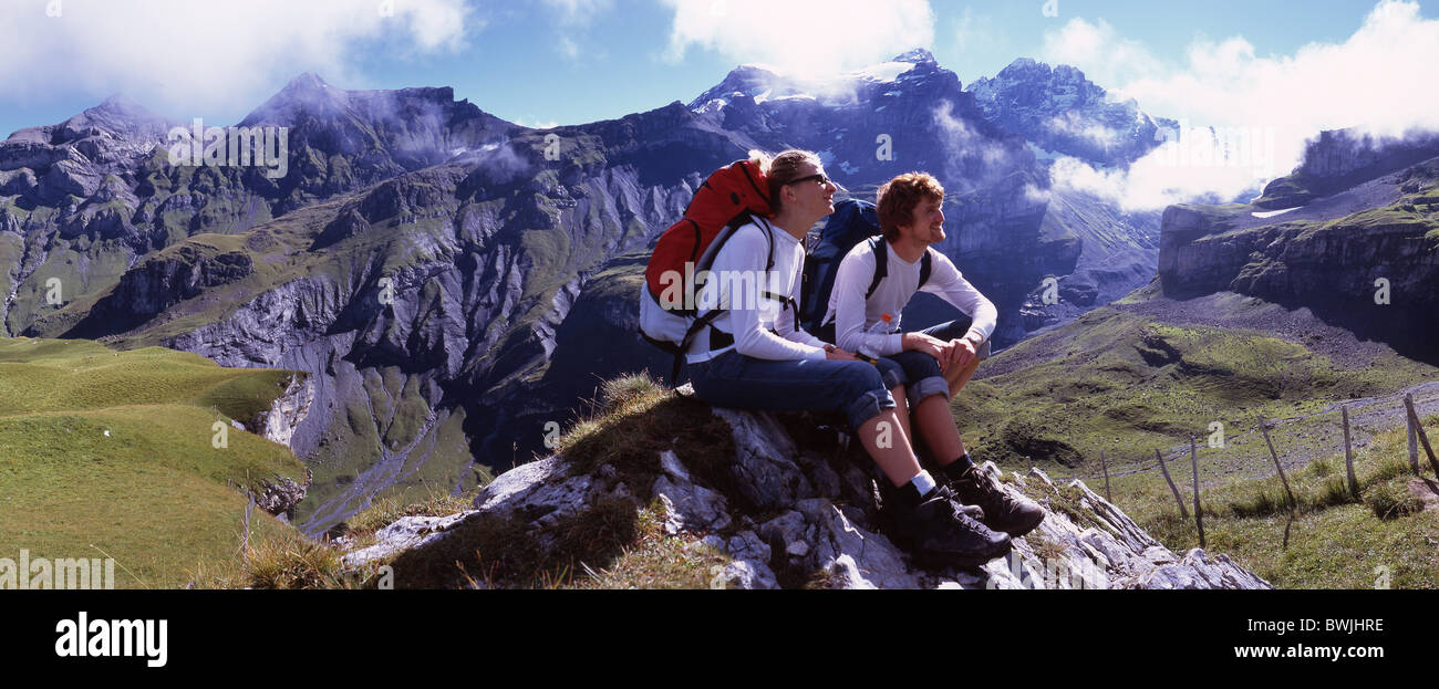 couple rest break stop sit observing scenery landscape hiker mountain ...