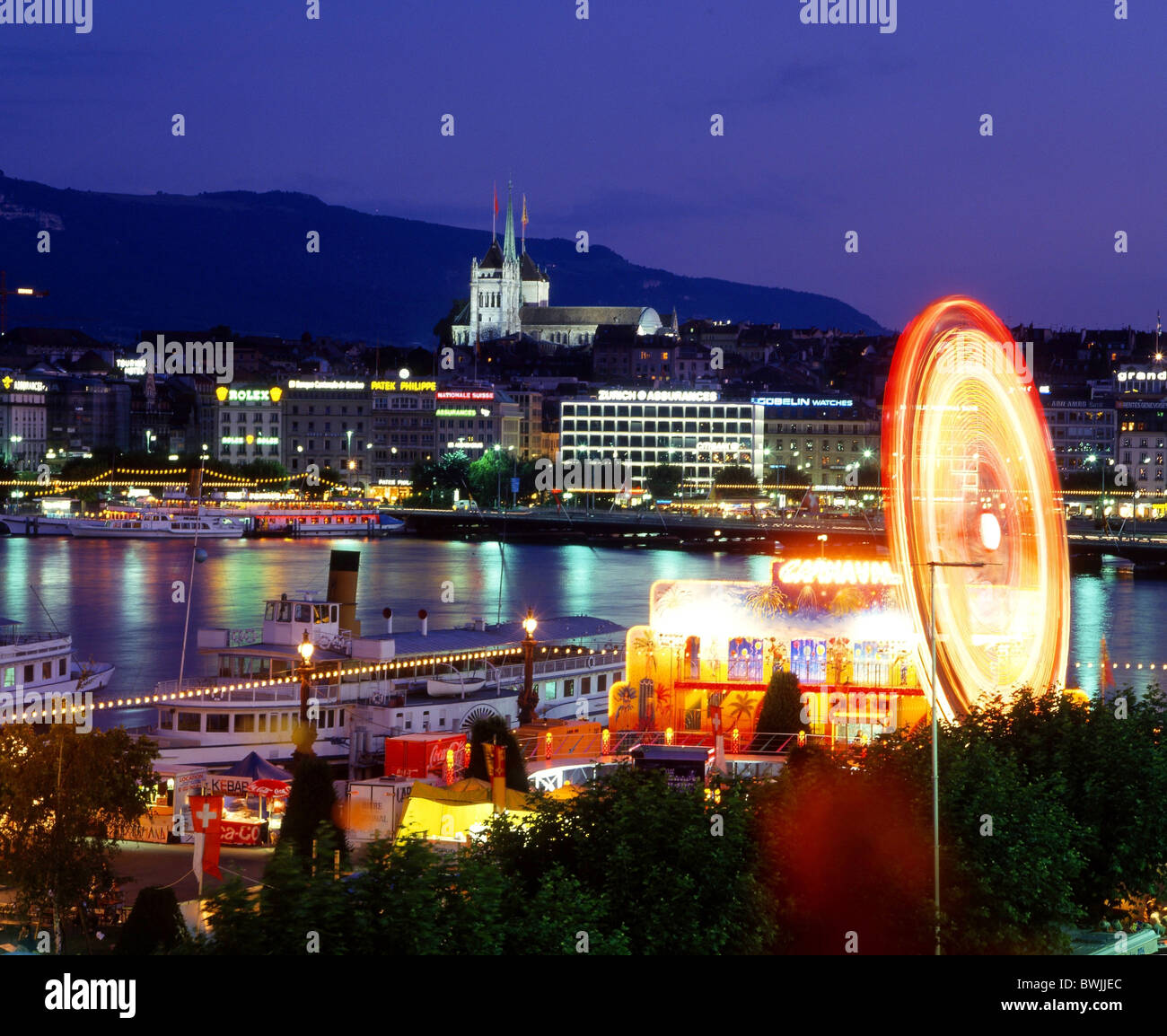 town city of Geneva at night night big dipper fair fairground ships ...