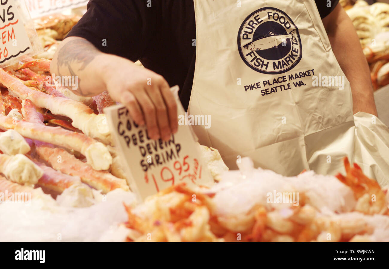 A fishmonger sells fish from the Pure Food Fish Market at Pike Place ...