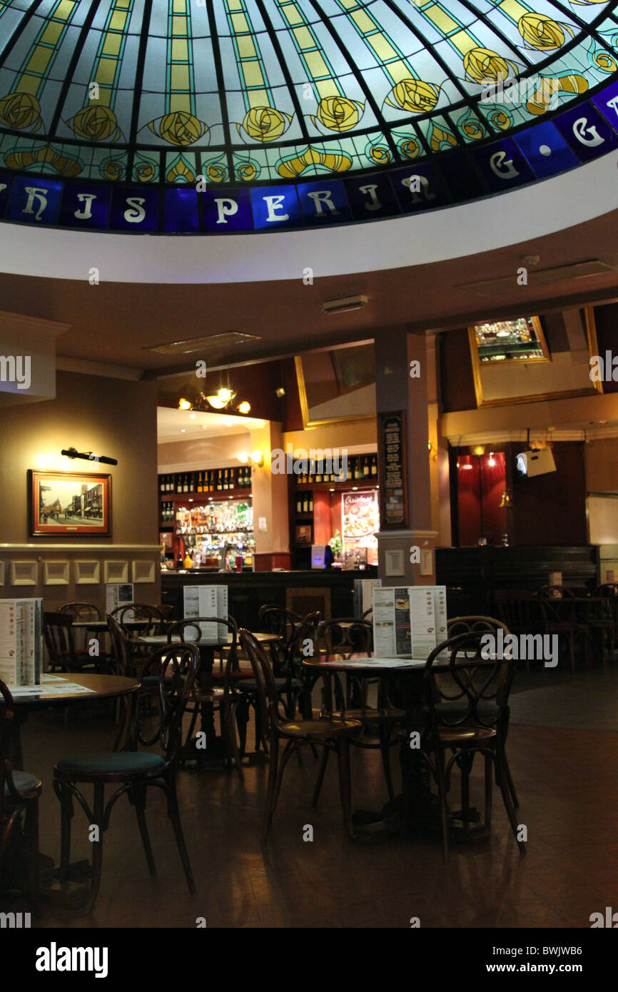 Seating area and bar within a British pub which features a whispering ...