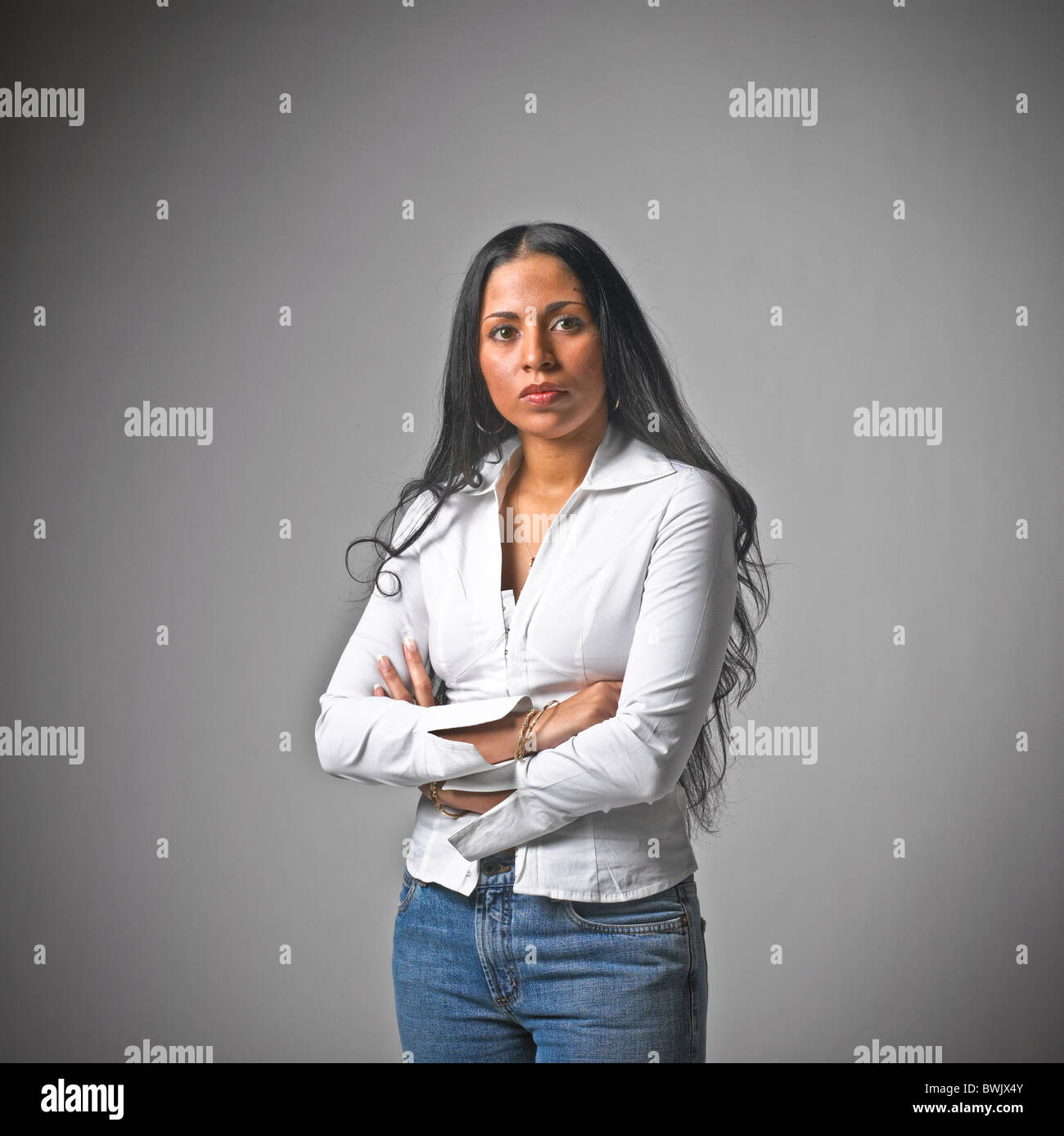 Young Hispanic woman female casual clothes, jeans, body language, arms ...