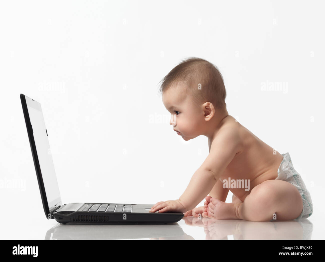 Six month old baby sitting in front of a laptop computer Stock Photo ...
