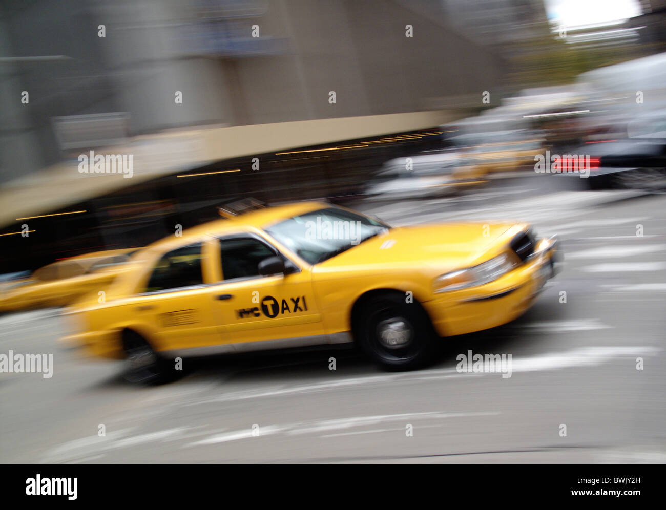 A yellow New York City taxi cab in motion in the United States of ...
