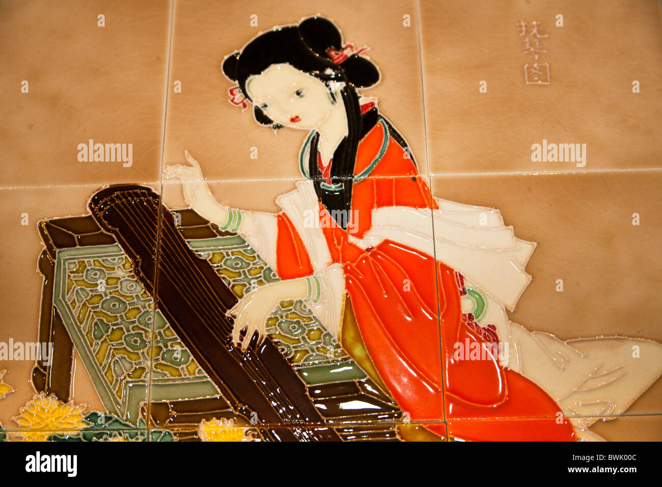 Chinese woman playing a stringed musical instrument depicted on ceramic ...
