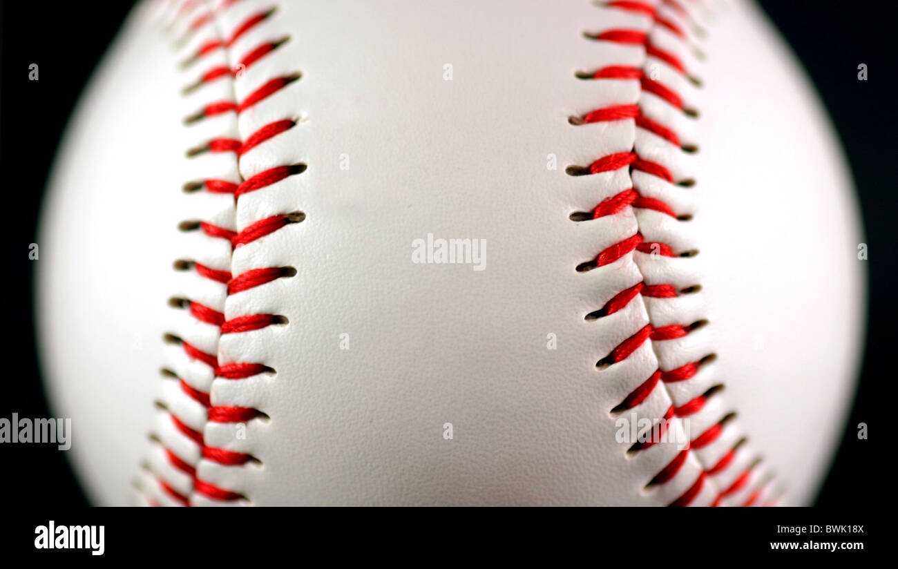 white leather baseball with red stitching on black background Stock ...