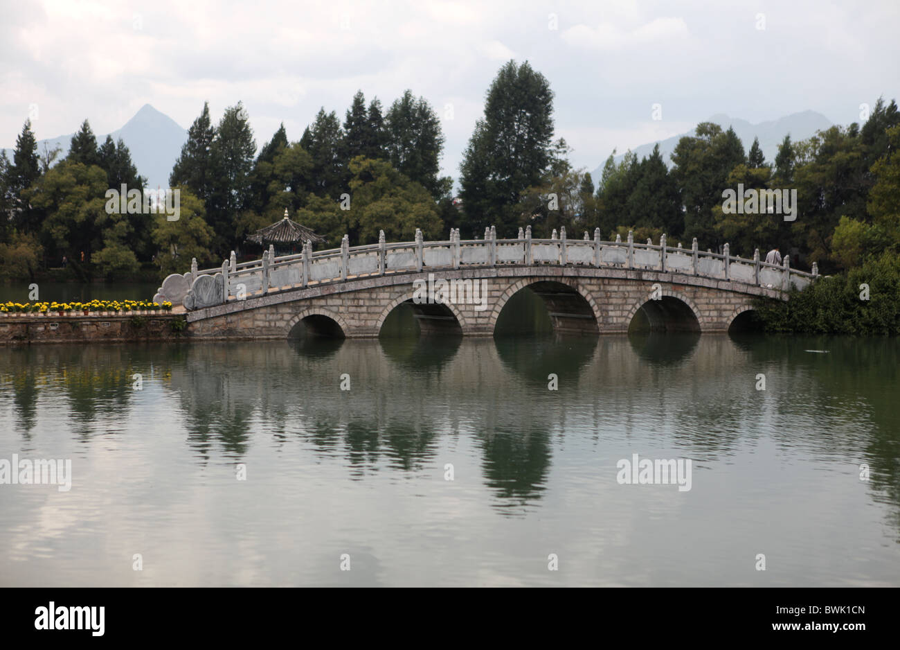 The large traditional stone bridge in Black Dragon Pool Park in Lijiang ...