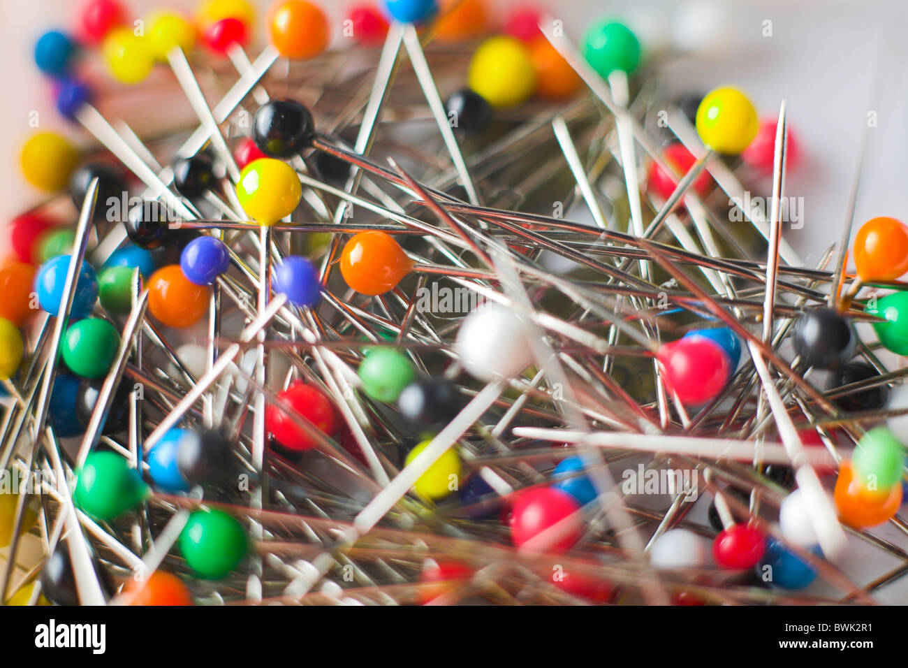 Stack of Needles with multi colored heads Stock Photo - Alamy