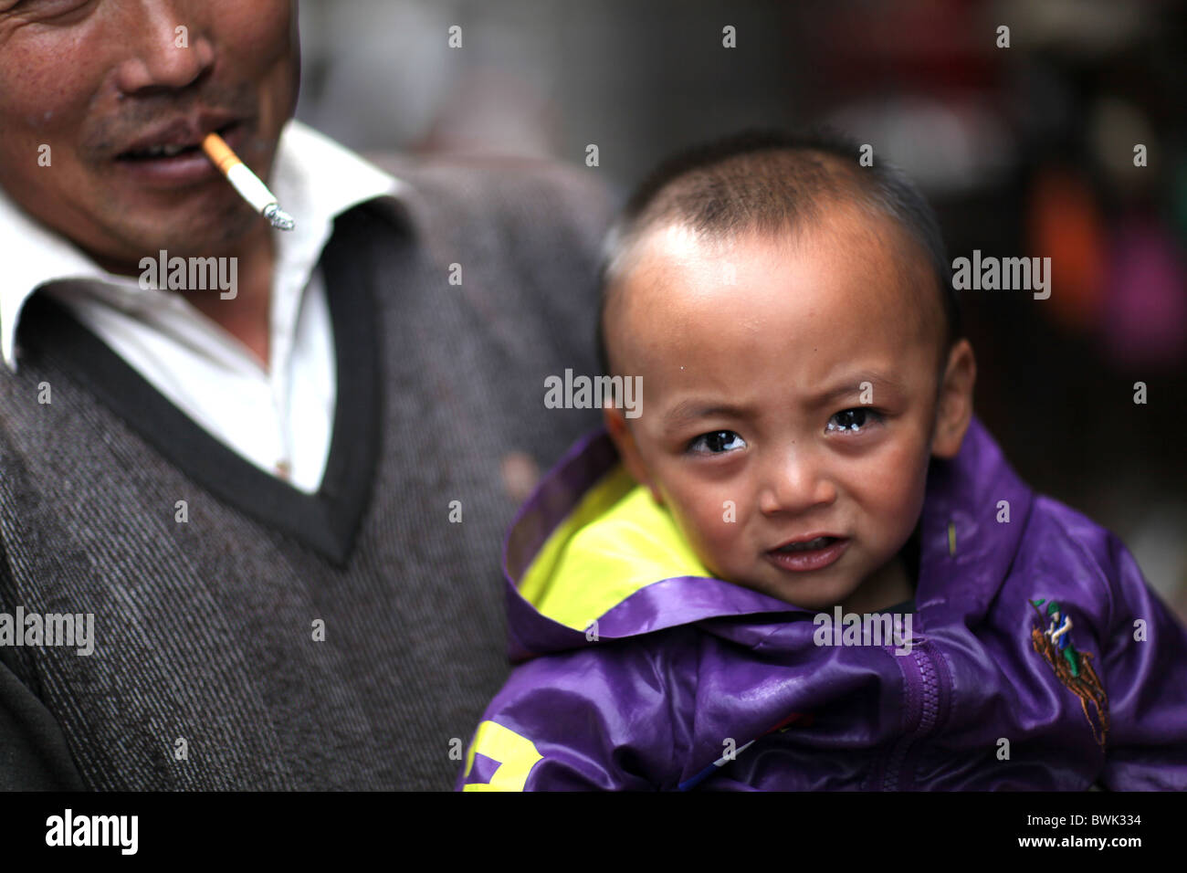 A young chinese boy with his father in Lijiang Old town, Yunnan ...