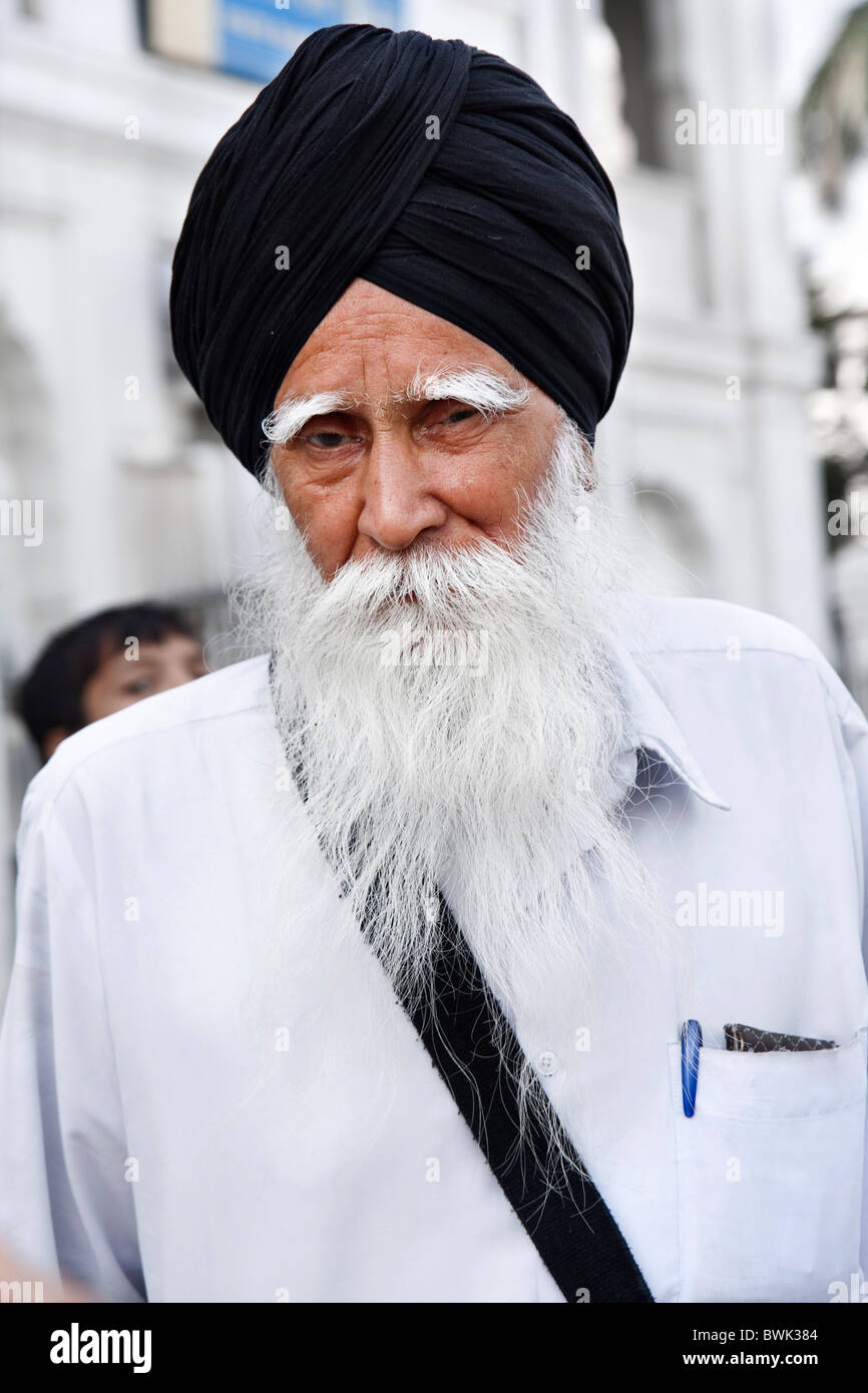a Sikh looking into the camera at the Golden Temple, Amritsar, Punjab ...