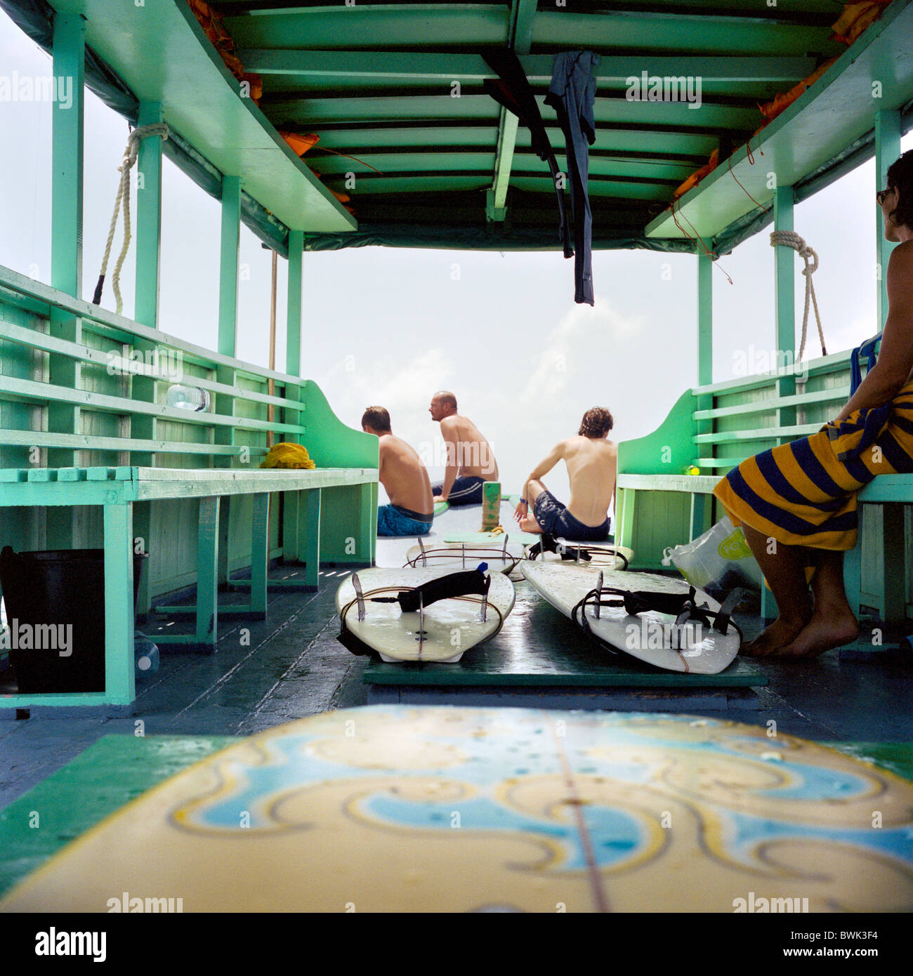 Maldives, local boat transporting surfers and surfboards to surf break ...
