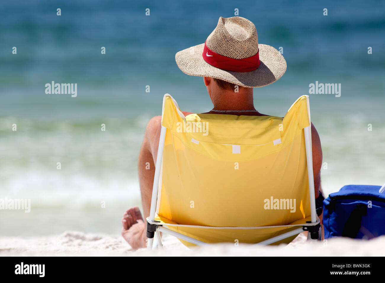 Man relaxing on a beach chair watching the surf Stock Photo - Alamy