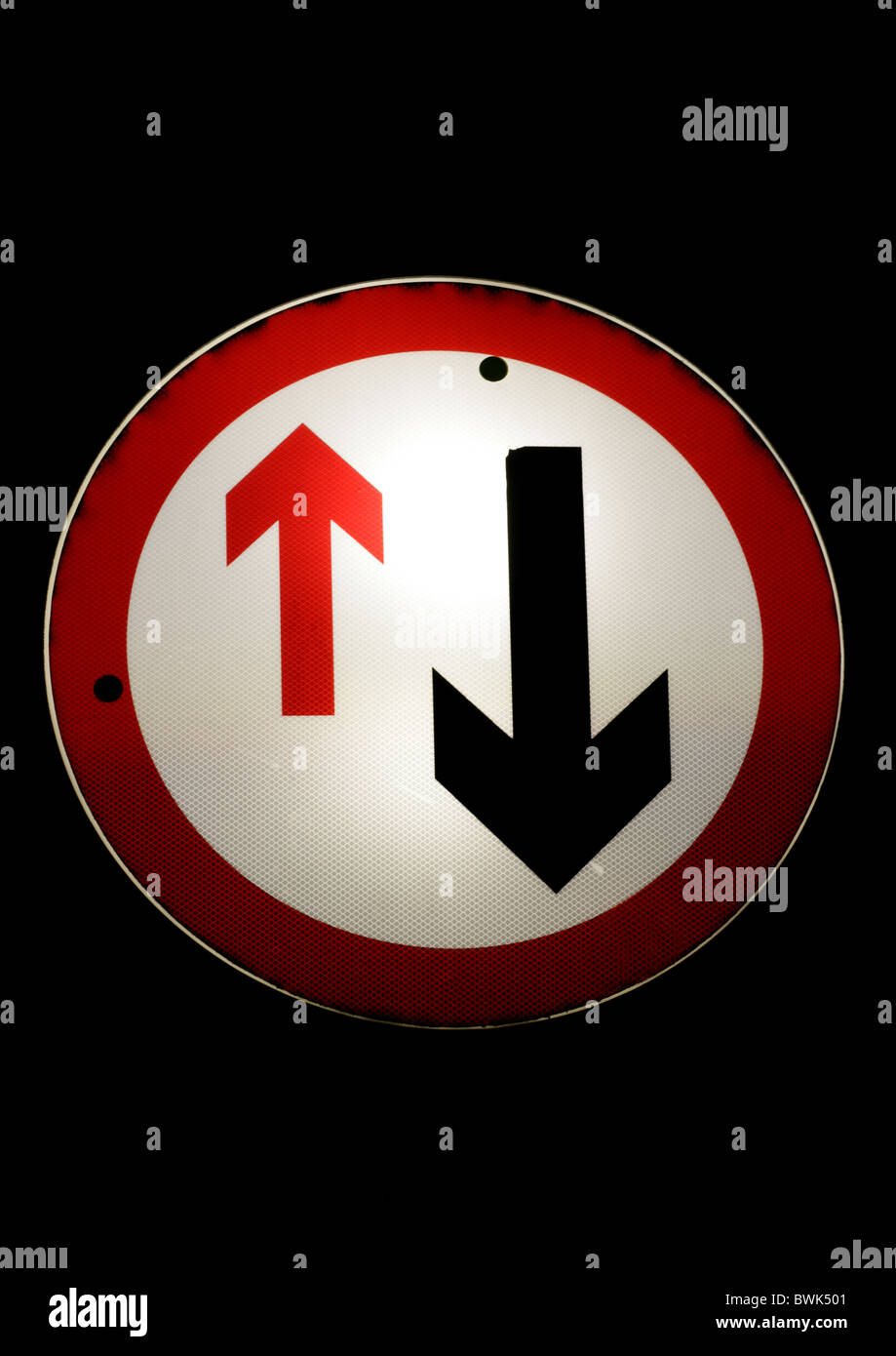Direction Road sign at night Stock Photo - Alamy