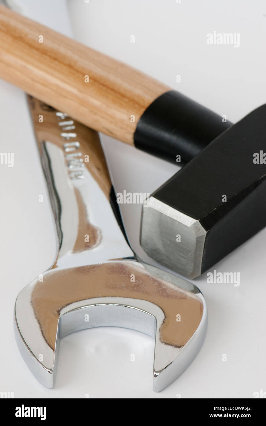 Hammer and wrench on white Stock Photo - Alamy