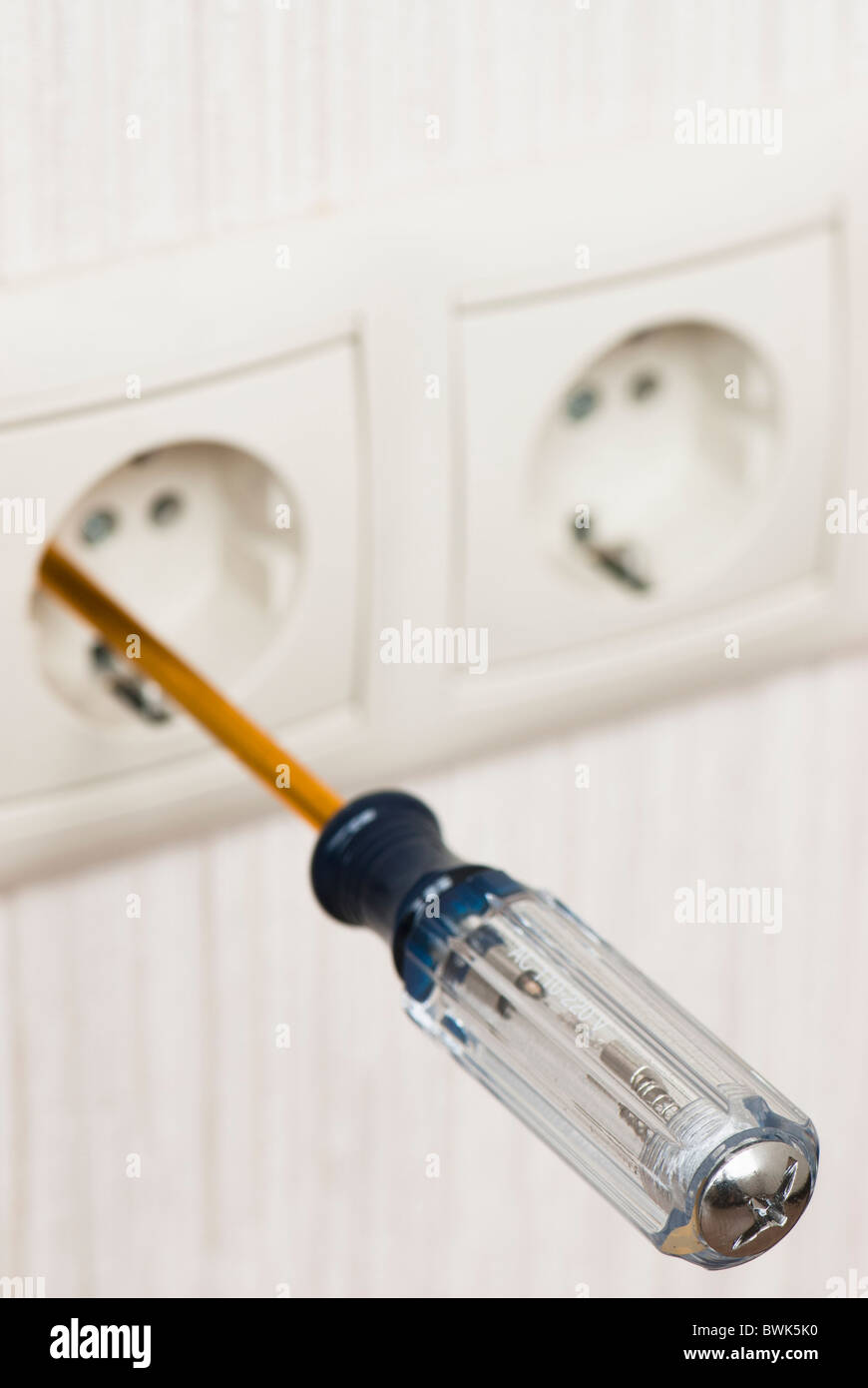 Electrician's screwdriver plugged into the socket Stock Photo - Alamy