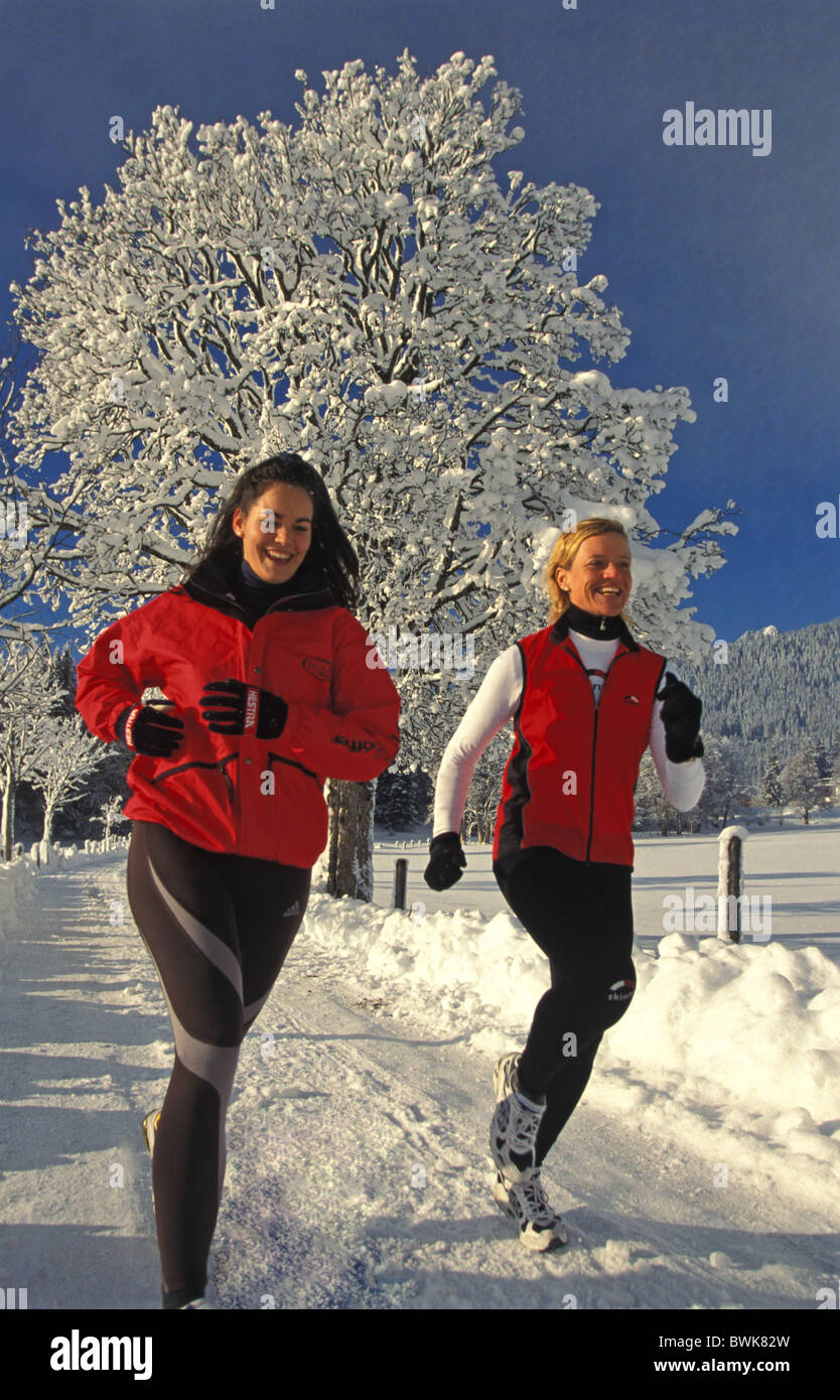 winter Jogging Two women woman running running training country lane ...