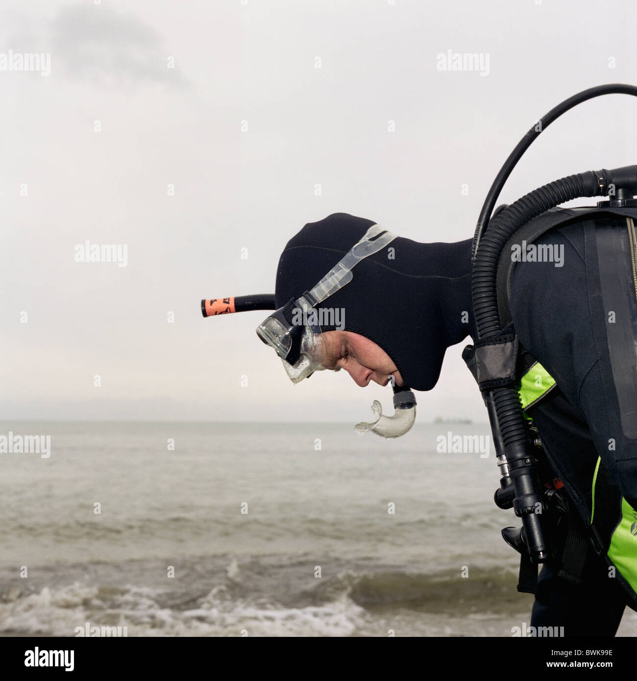 Man getting into diving gear on a Cornish beach Stock Photo - Alamy