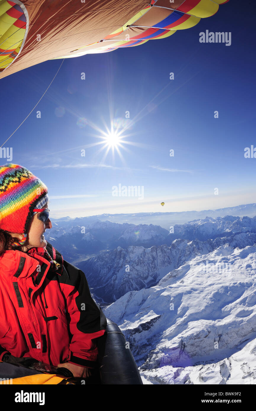 Woman in hot-air balloon enjoying view to Pala range in winter, aerial ...