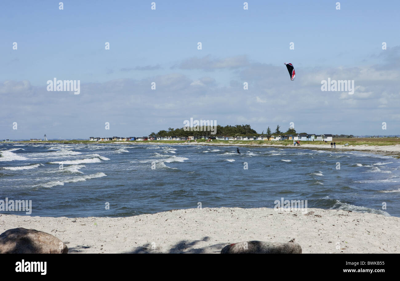 Kite surfer with little beach huts in the background at Skanoer beach ...