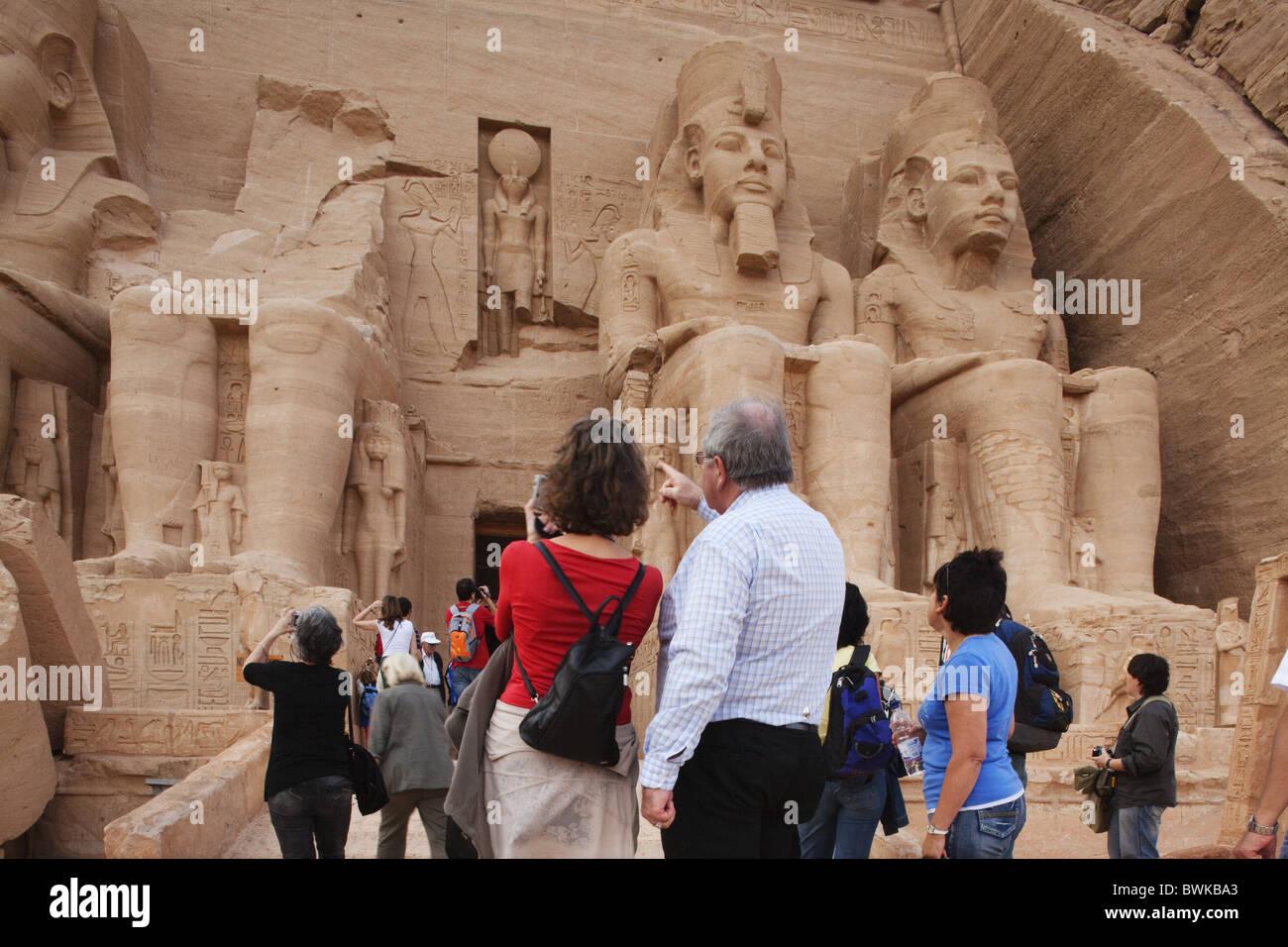 Tourists in front of giant statues at Temple of Rameses II., Abu Simbel ...