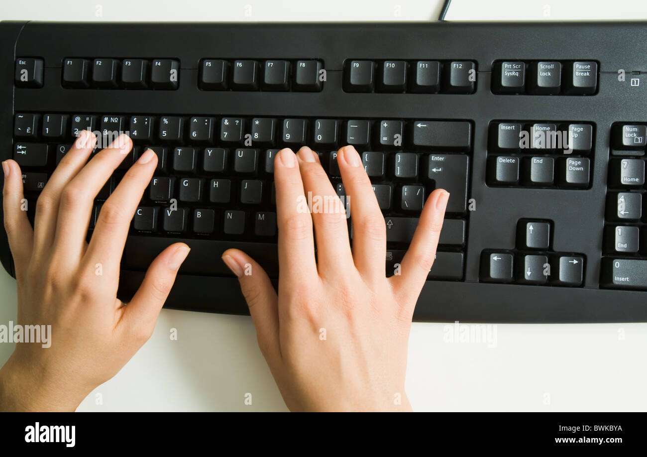 Above view of female hands typing on black keyboard at workplace Stock ...