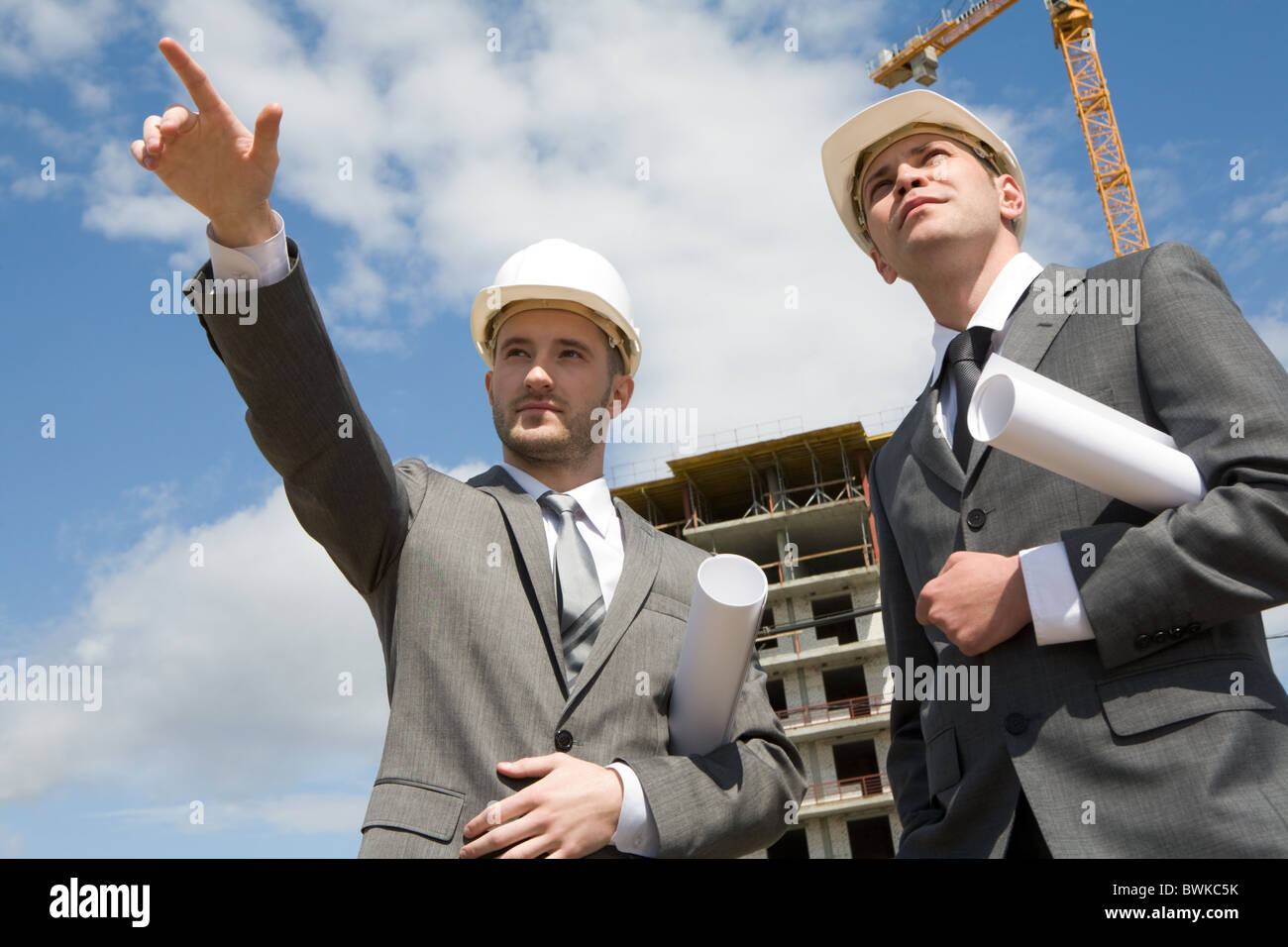 Photo of young engineer showing something to his colleague during ...
