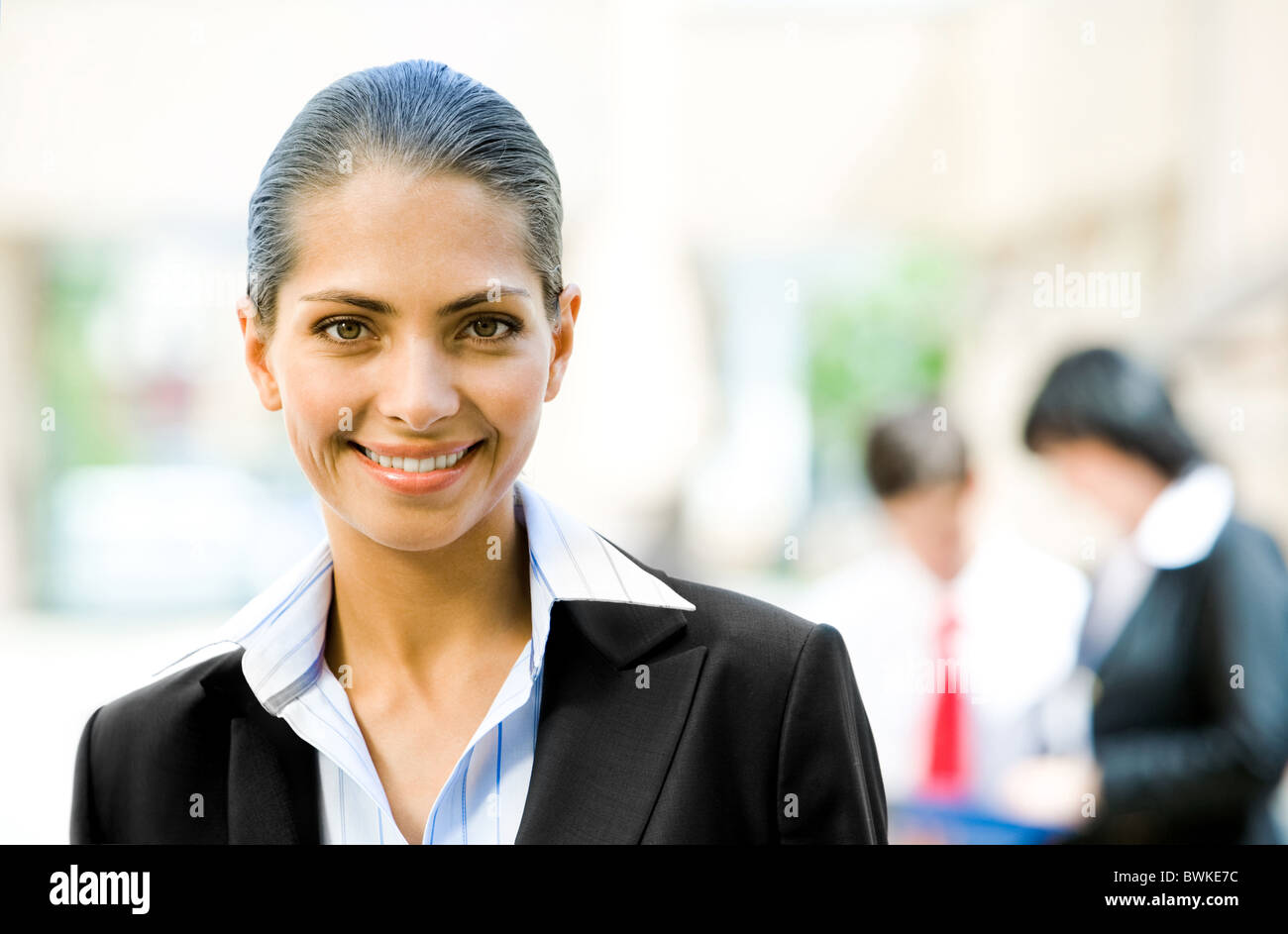 Portrait of pretty employer smiling at camera in working environment ...