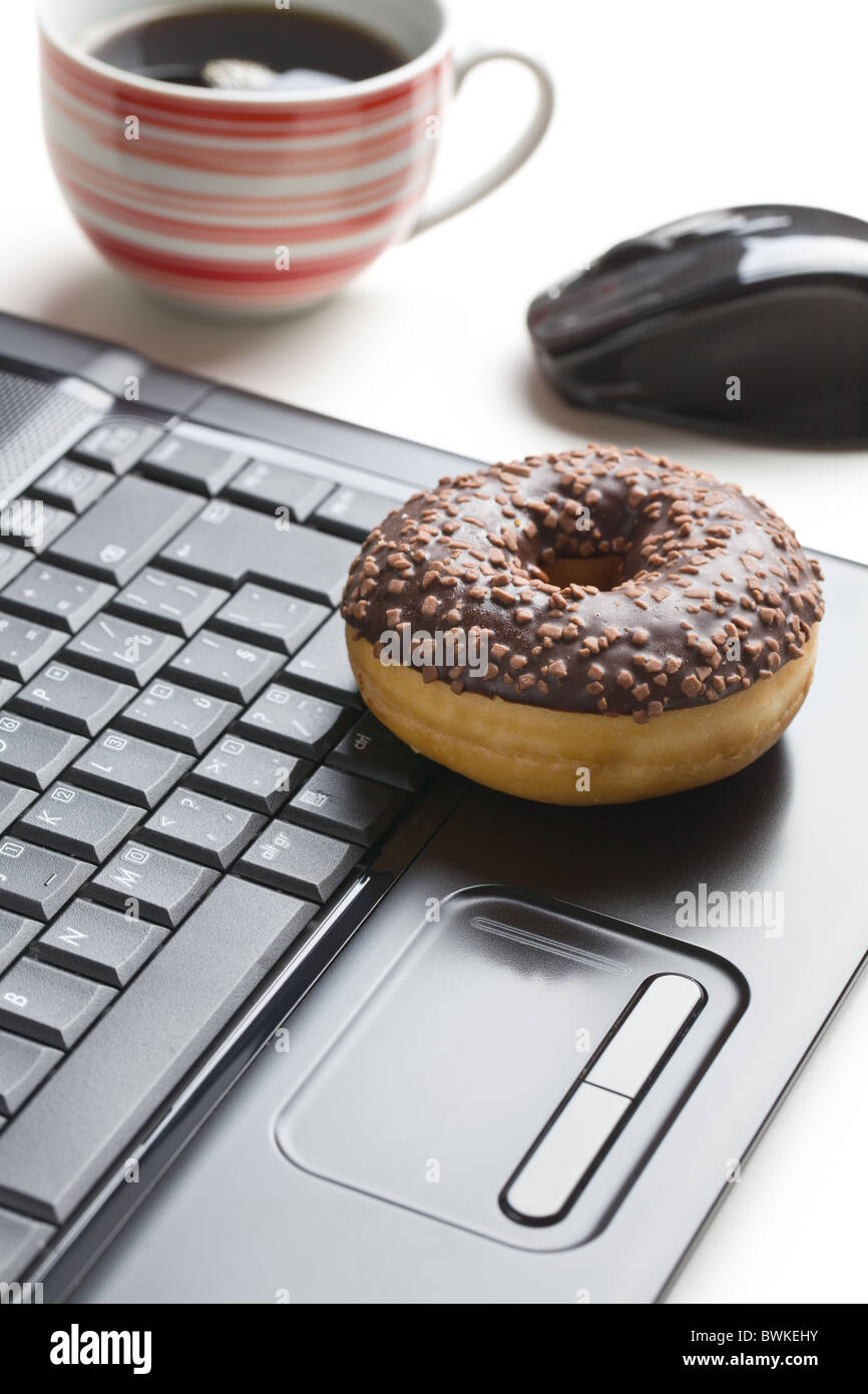the break in the office . doughnut on laptop keyboard Stock Photo - Alamy
