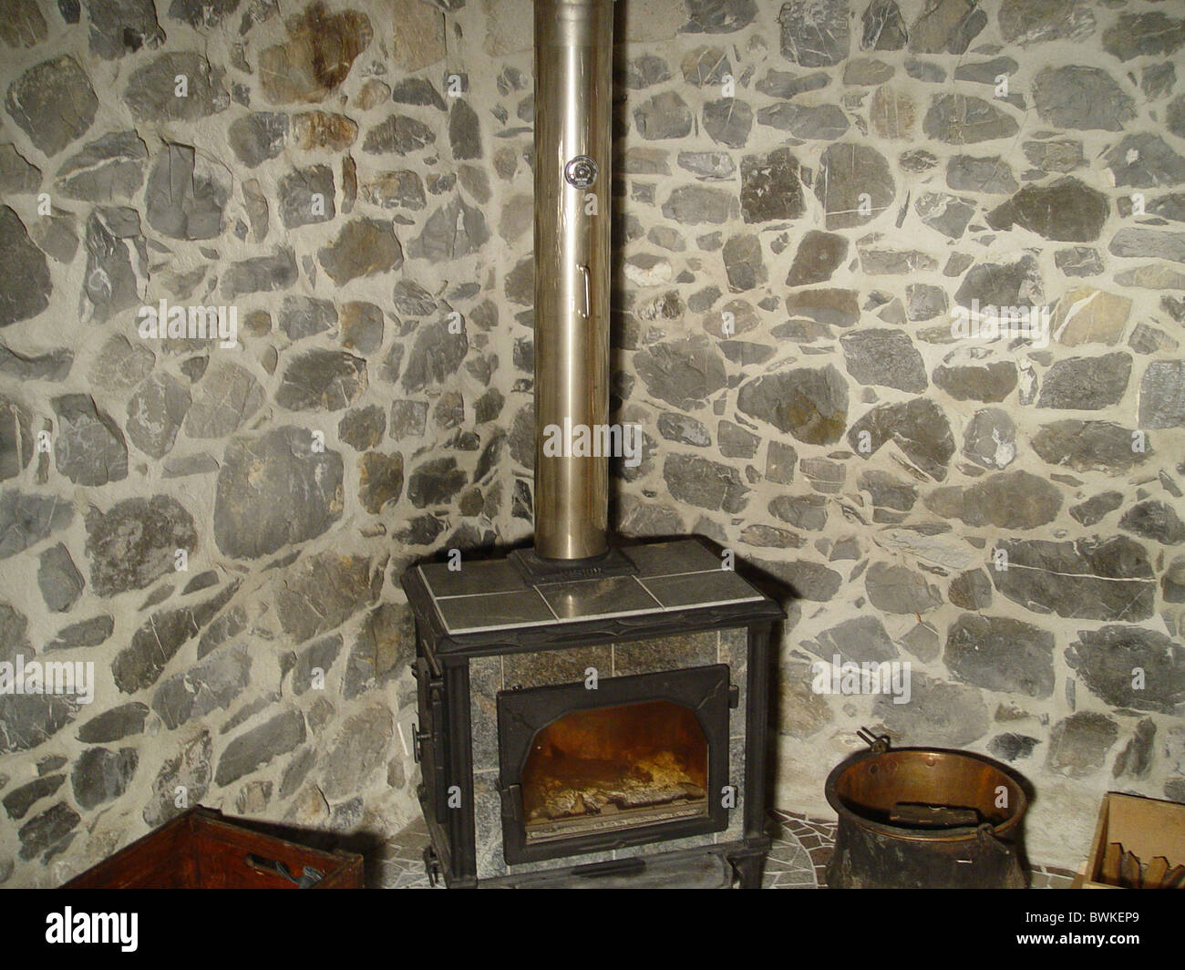 stove wooden stove Cheminée rustic wood heating stone wall Switzerland ...