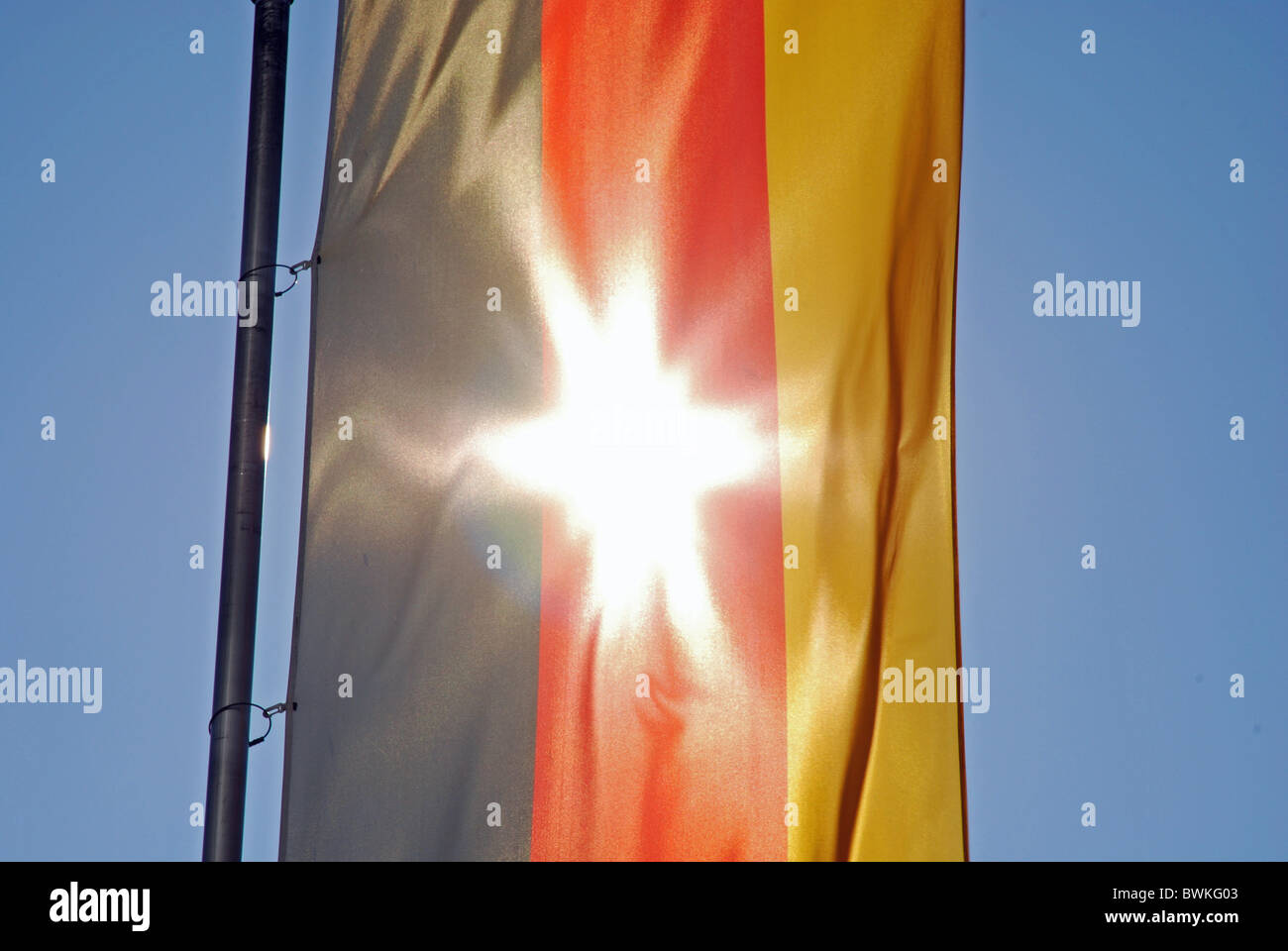 German flag flag banner back light sun Germany Europe sky Stock Photo ...