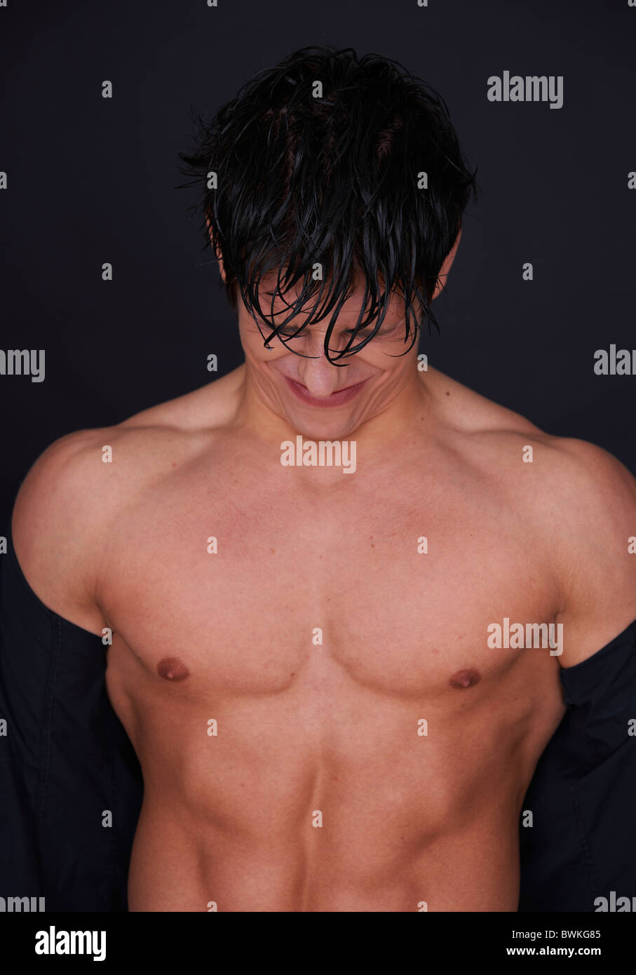 Athletic young man with a bare chest and clenched teeth Stock Photo - Alamy