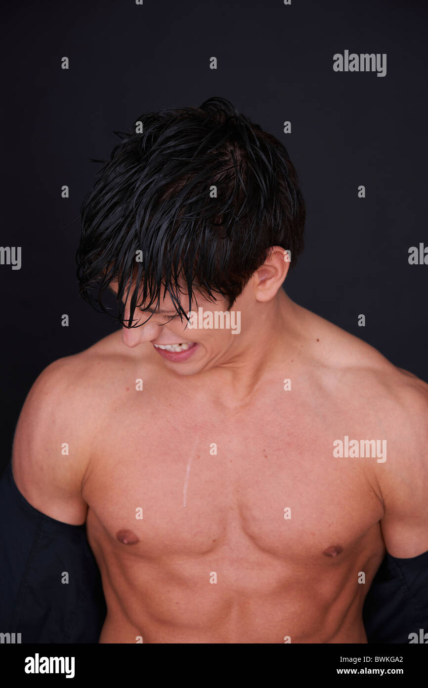 Athletic young man with a bare chest and clenched teeth Stock Photo - Alamy