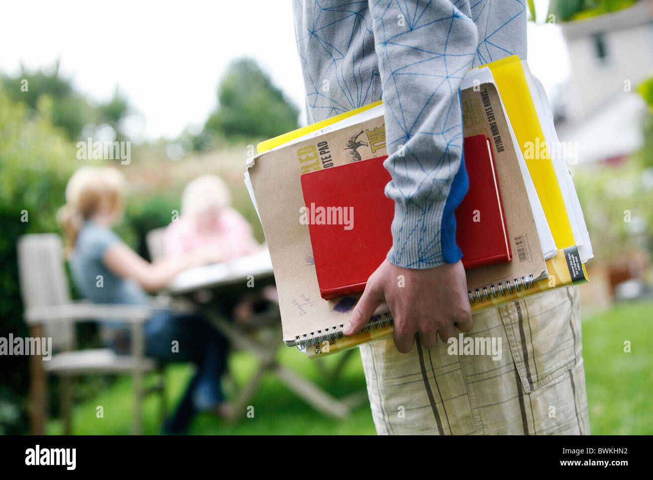 Male university student carrying her folders and books for studying in ...