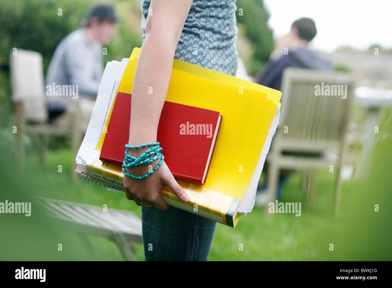 Female university student carrying her folders and books for studying ... Female university student carrying her folders and books for studying ...