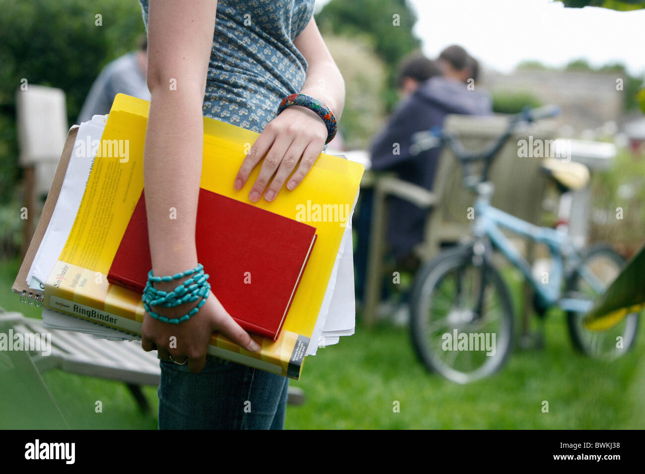 Female university student carrying her folders and books for studying ...