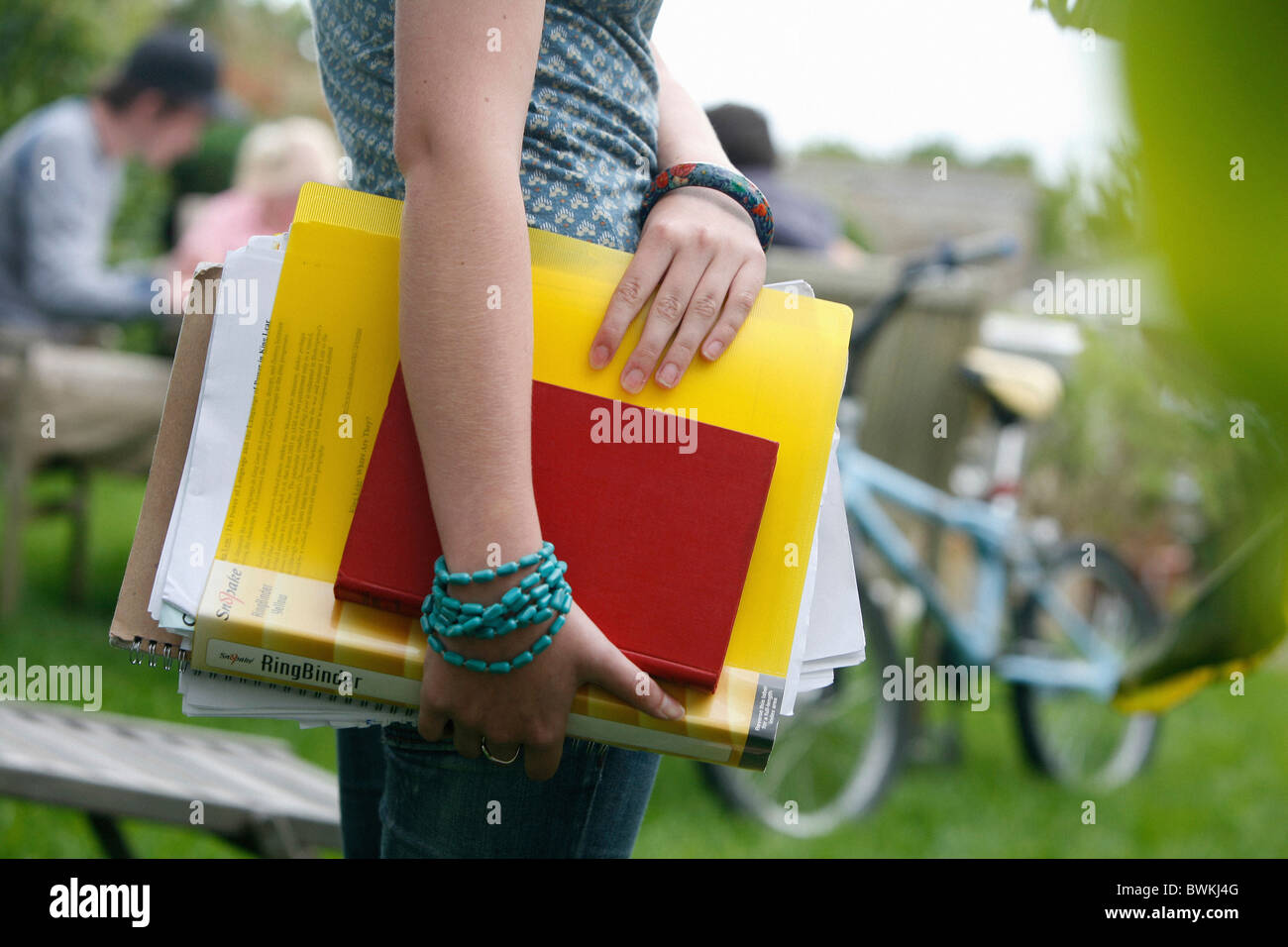 Female university student carrying her folders and books for studying ...