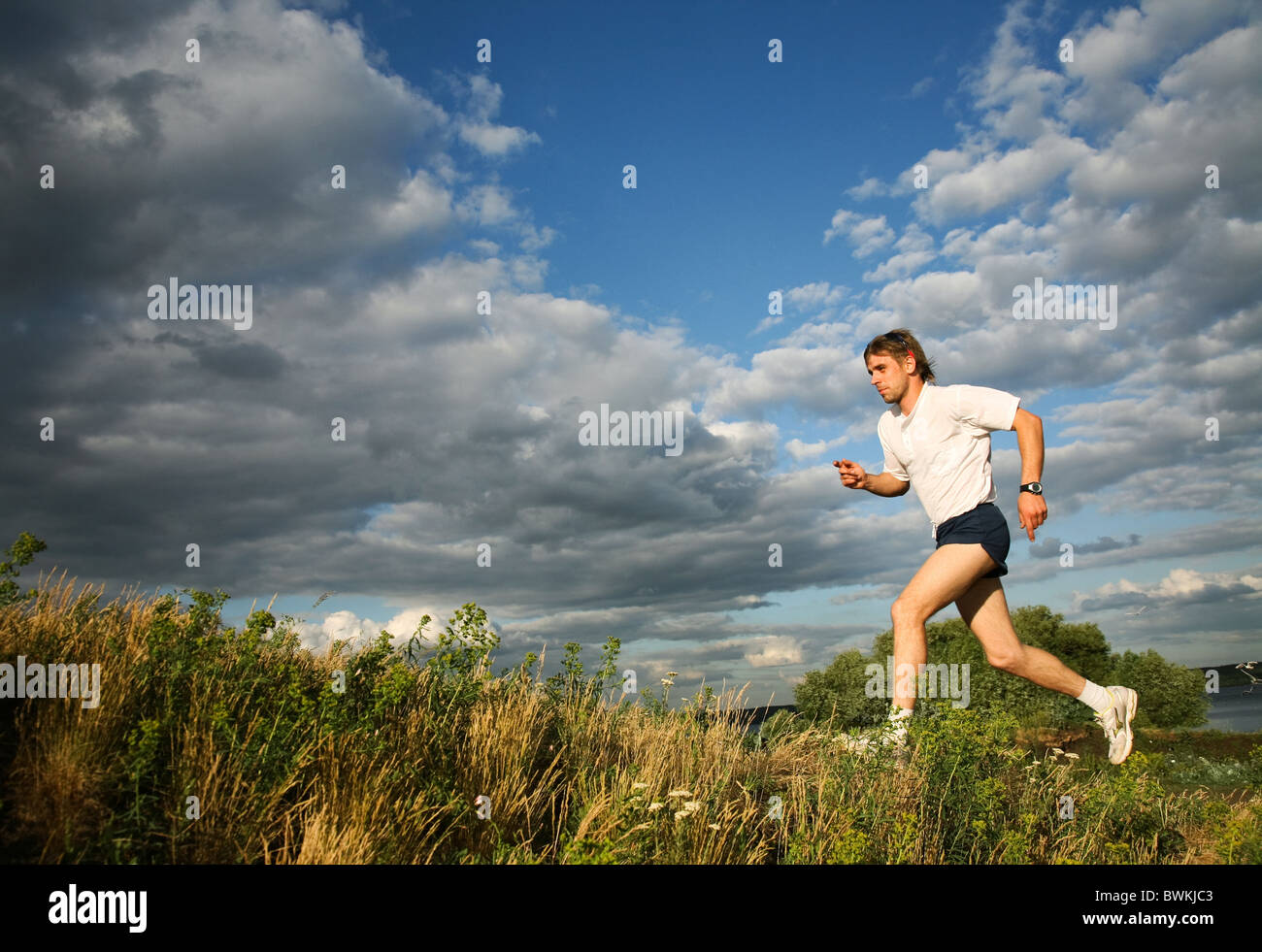 Photo of strong man running along the river Stock Photo - Alamy