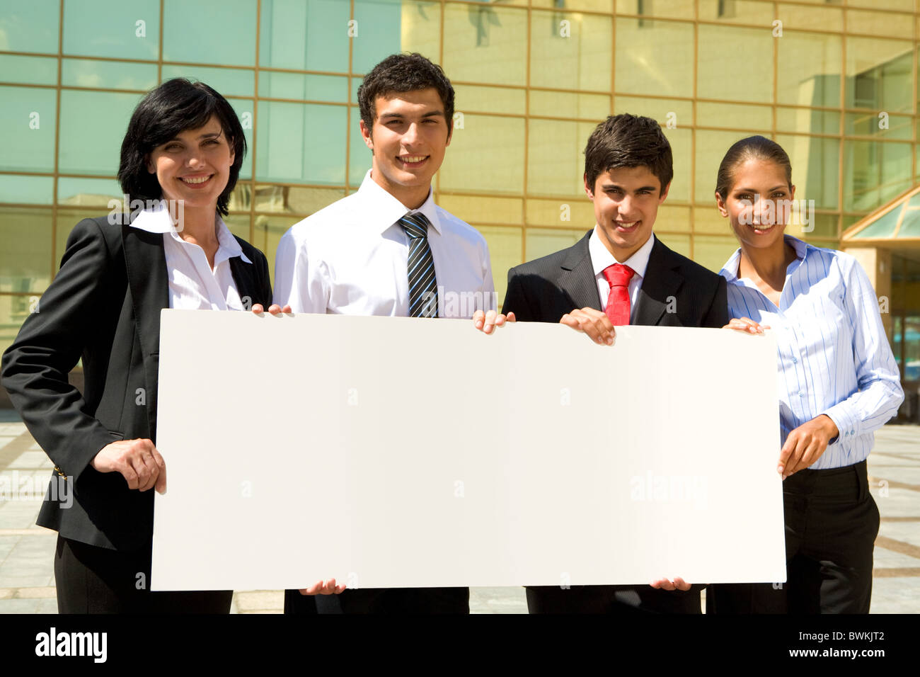 Portrait of team of people holding a paper outdoor Stock Photo - Alamy
