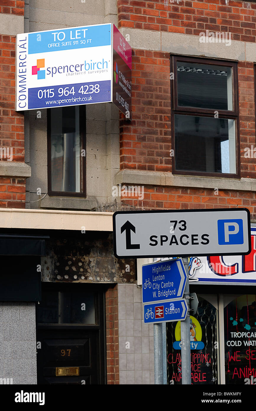 To Let, carp park, cycle paths and station signs on British High Street ...