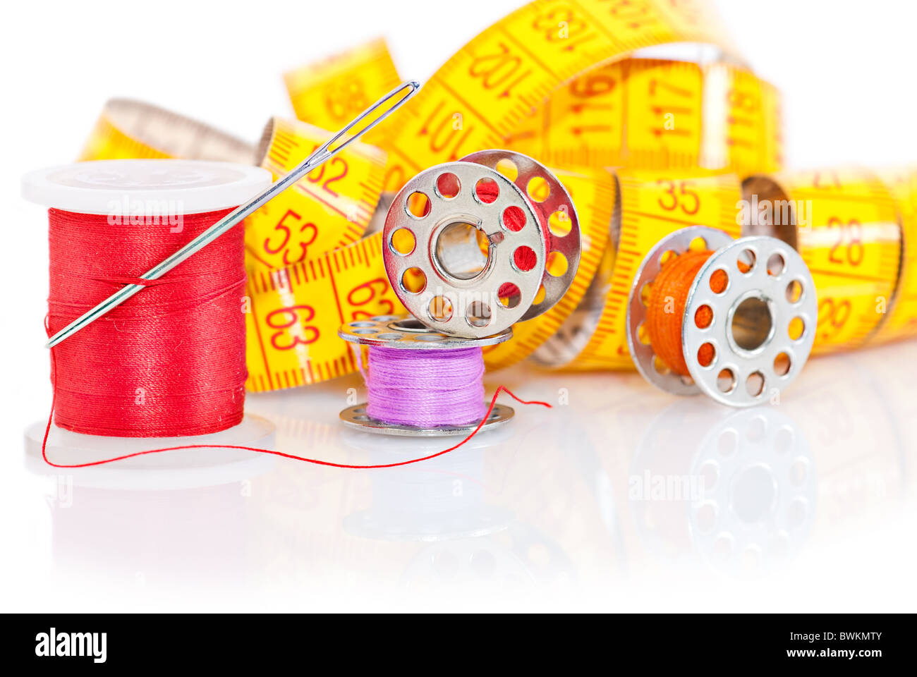 Colored bobbins for sewing and measuring tape over white Stock Photo ...