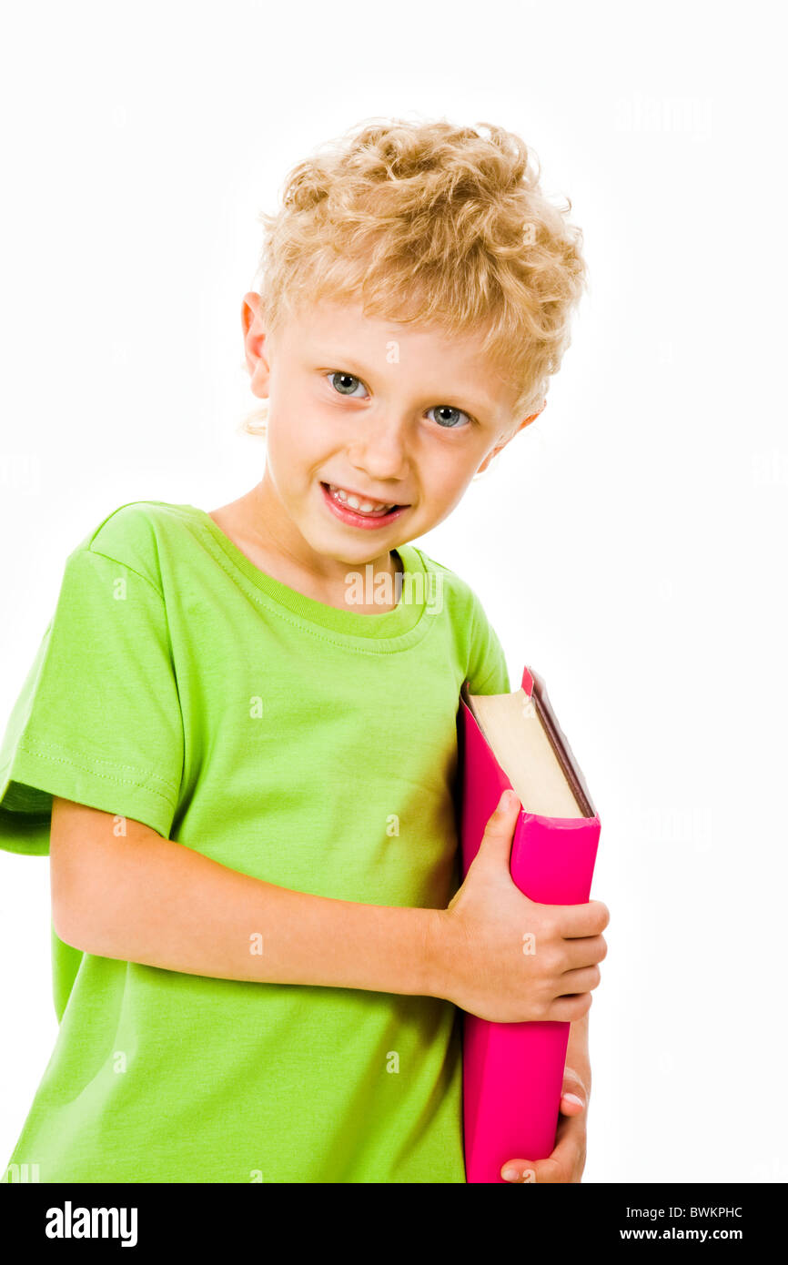 Portrait of smiling young boy holding book Stock Photo - Alamy