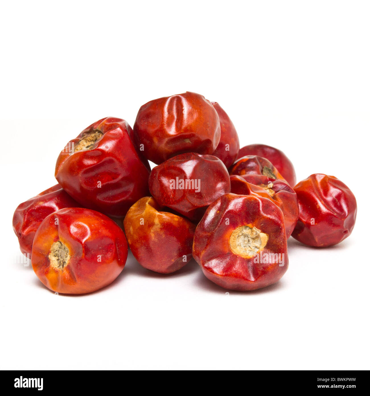 Dried whole round Chilli's from low perspective isolated on white Stock ...